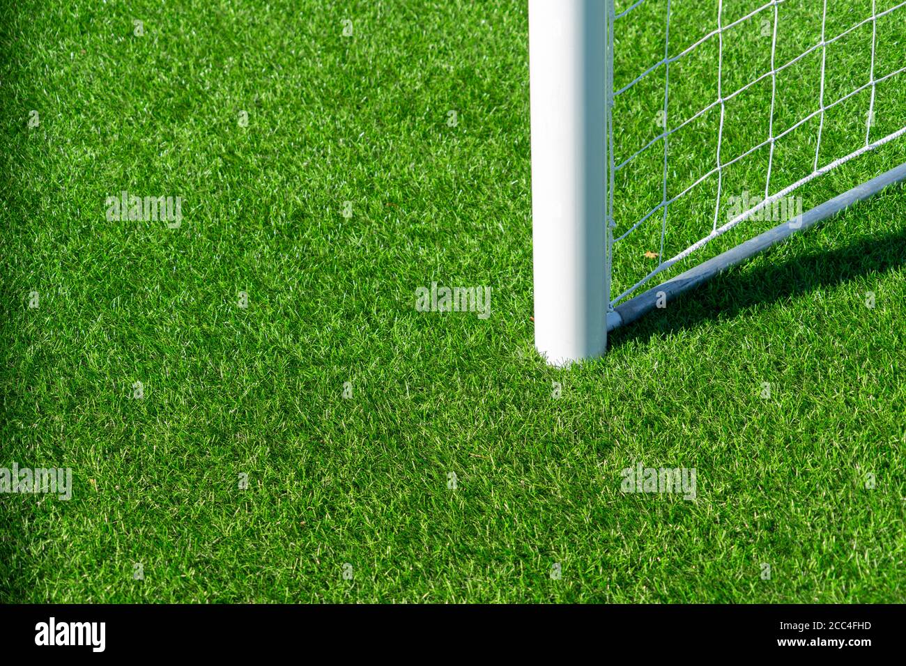 Close up of football soccer gate with white net and green grass ...