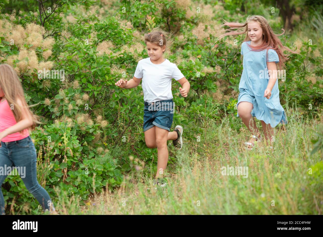 Best time. Kids, children running on green forest. Cheerful and happy ...