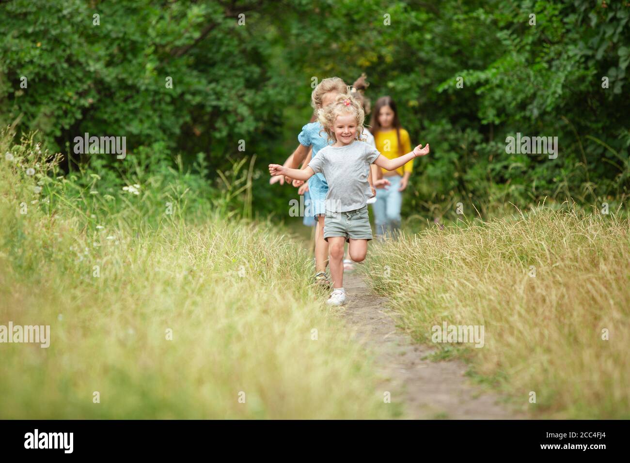 Carefree. Kids, children running on green forest. Cheerful and happy ...