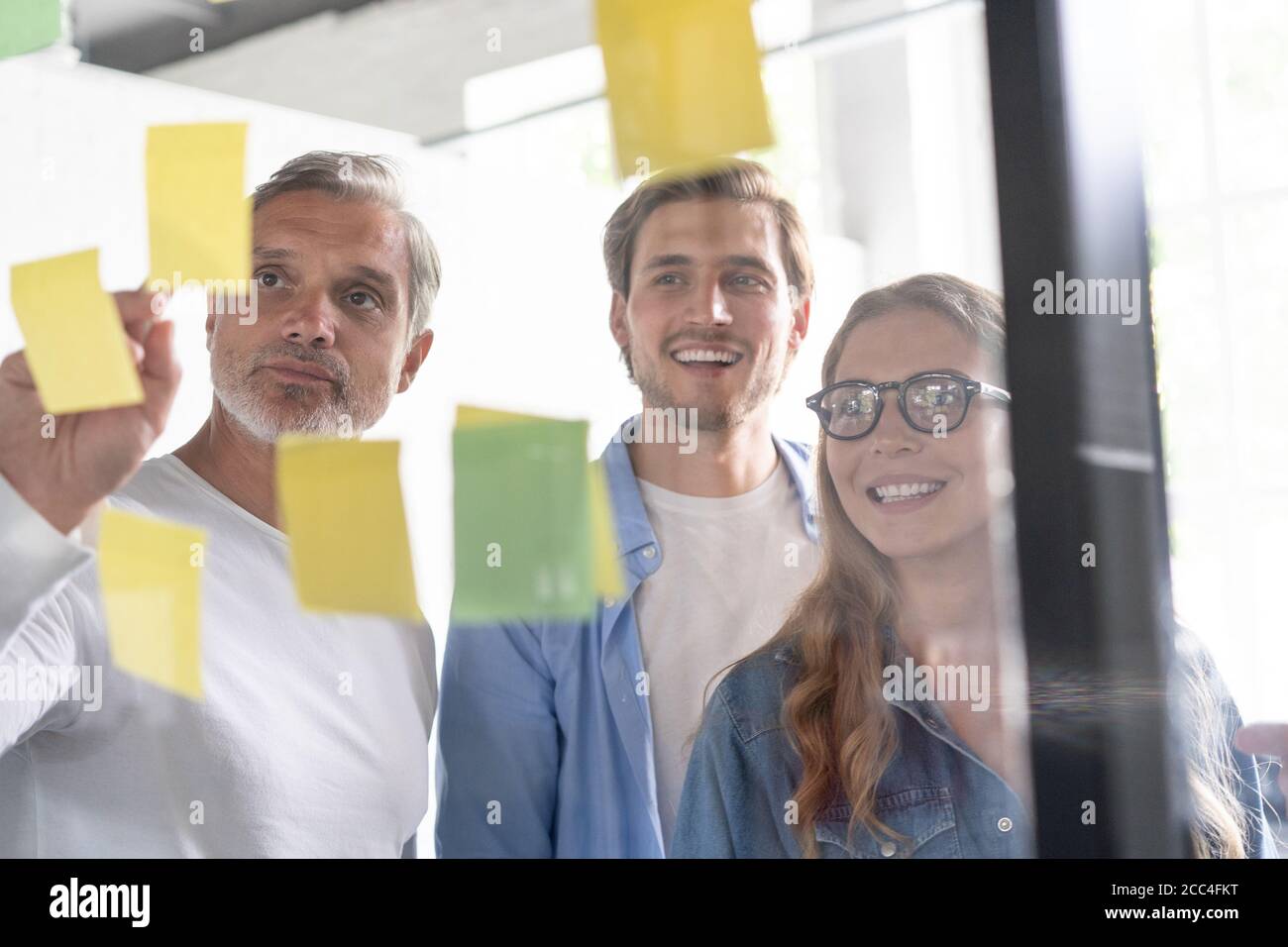 Business people meeting at office and use post it notes to share idea ...