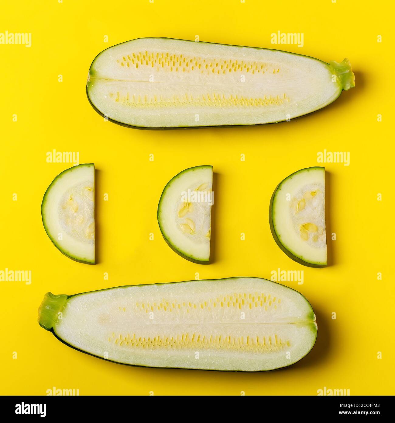 Zucchini slices on a yellow background. Creative Page Layout. Health ...