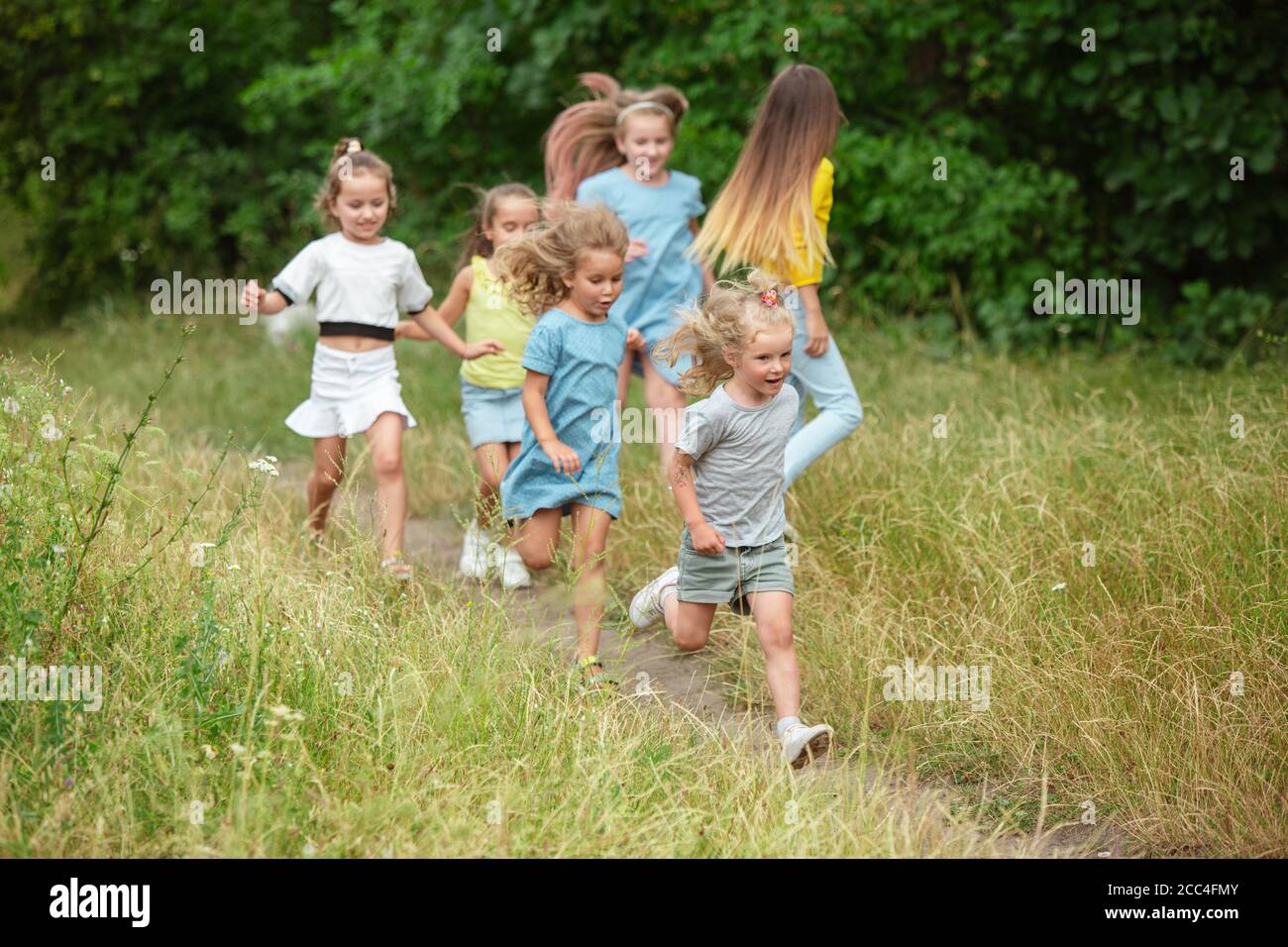 Carefree. Kids, children running on green forest. Cheerful and happy ...