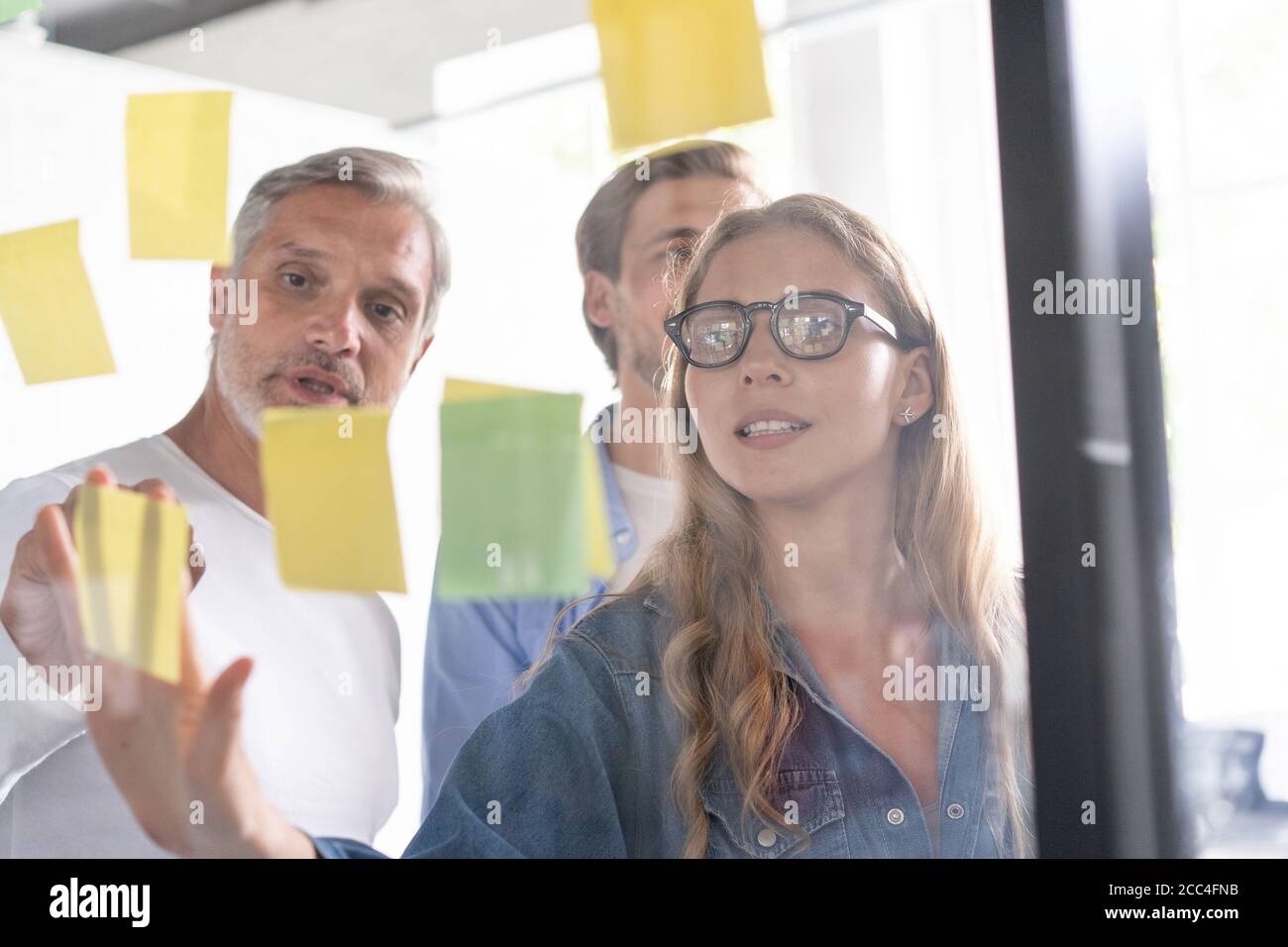 Business people meeting at office and use post it notes to share idea ...