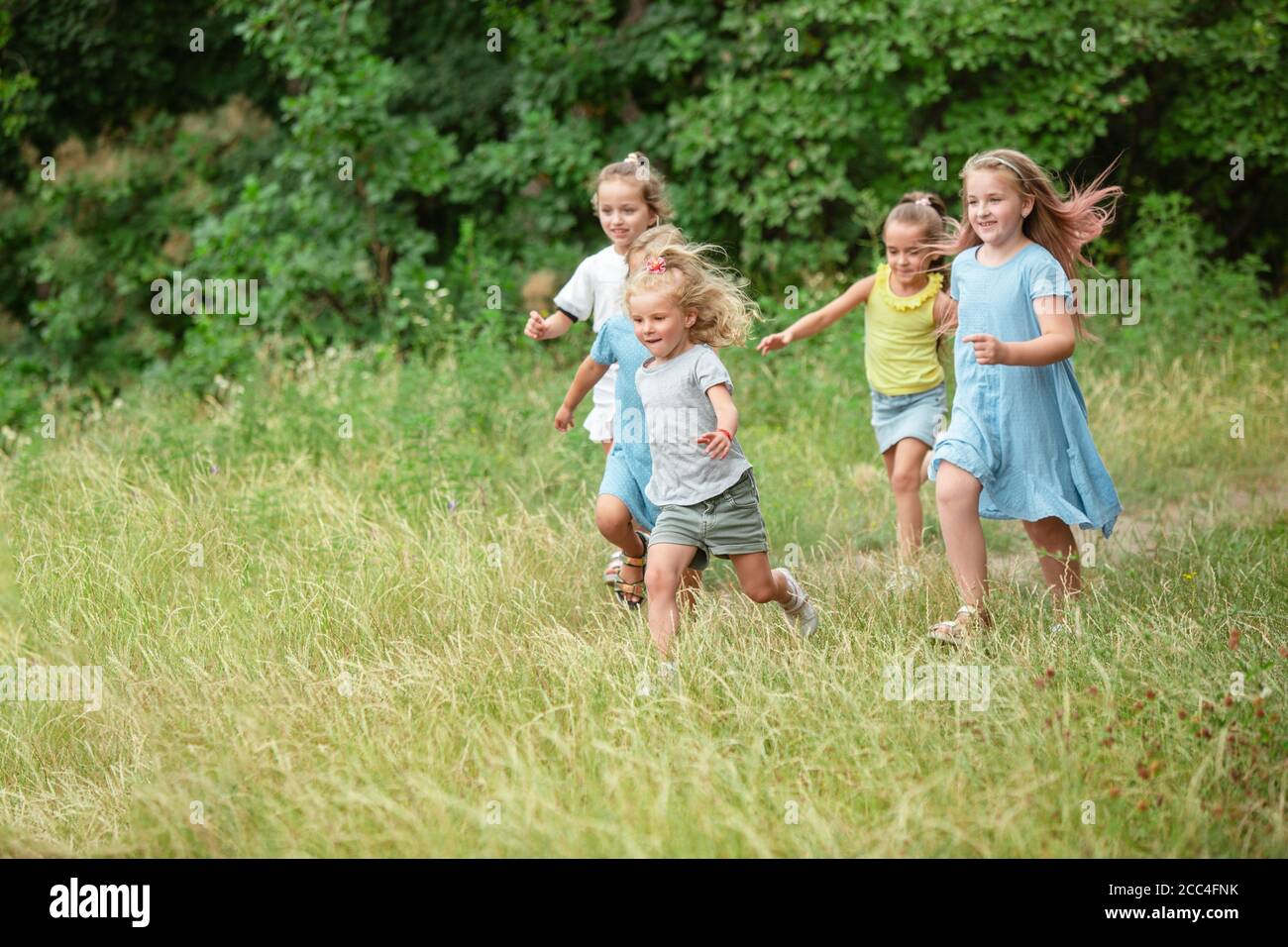 Carefree. Kids, children running on green forest. Cheerful and happy ...