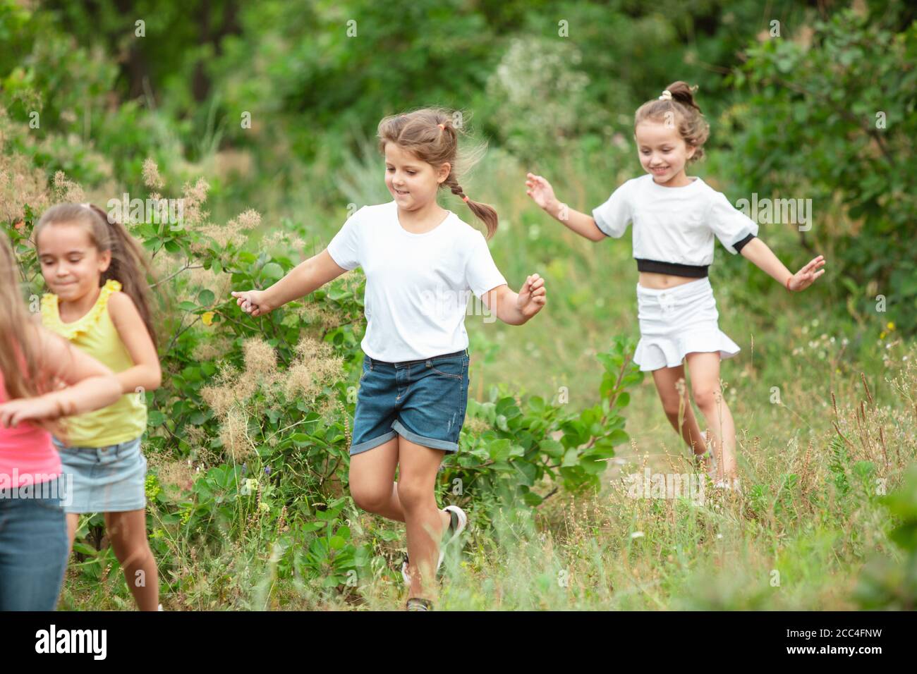 Best time. Kids, children running on green forest. Cheerful and happy ...