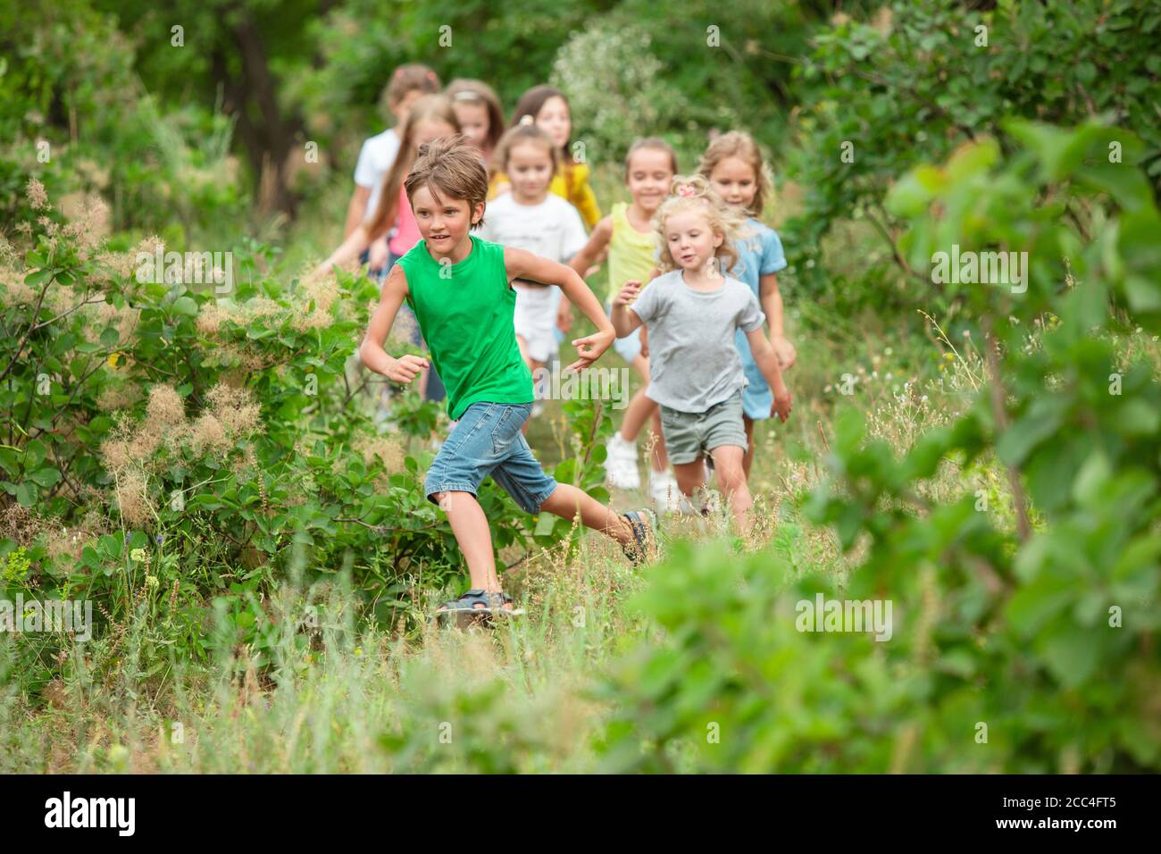 Best time. Kids, children running on green forest. Cheerful and happy ...