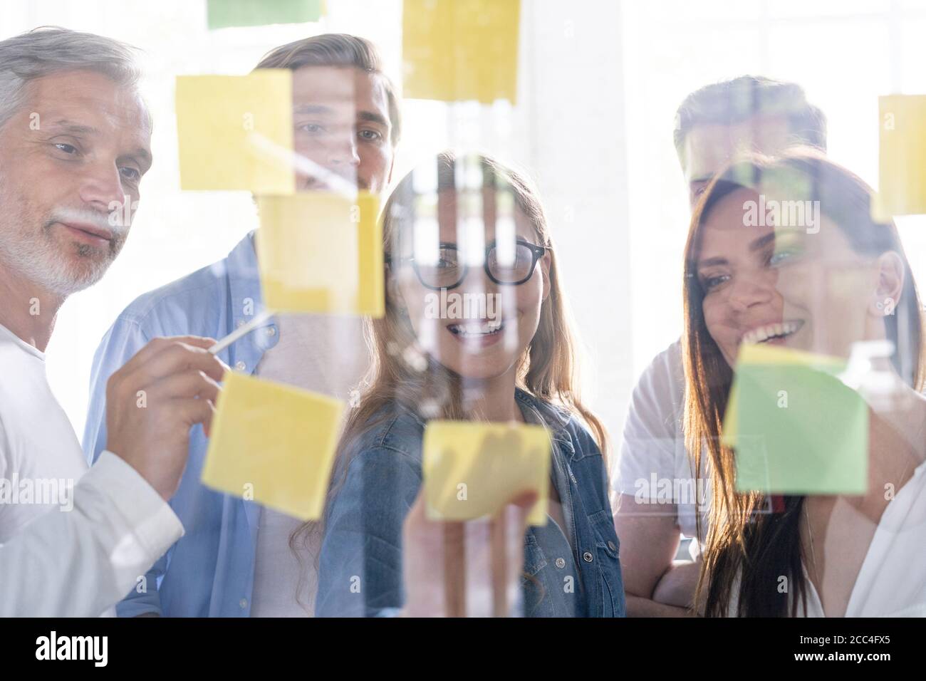 Business people meeting at office and use post it notes to share idea ...