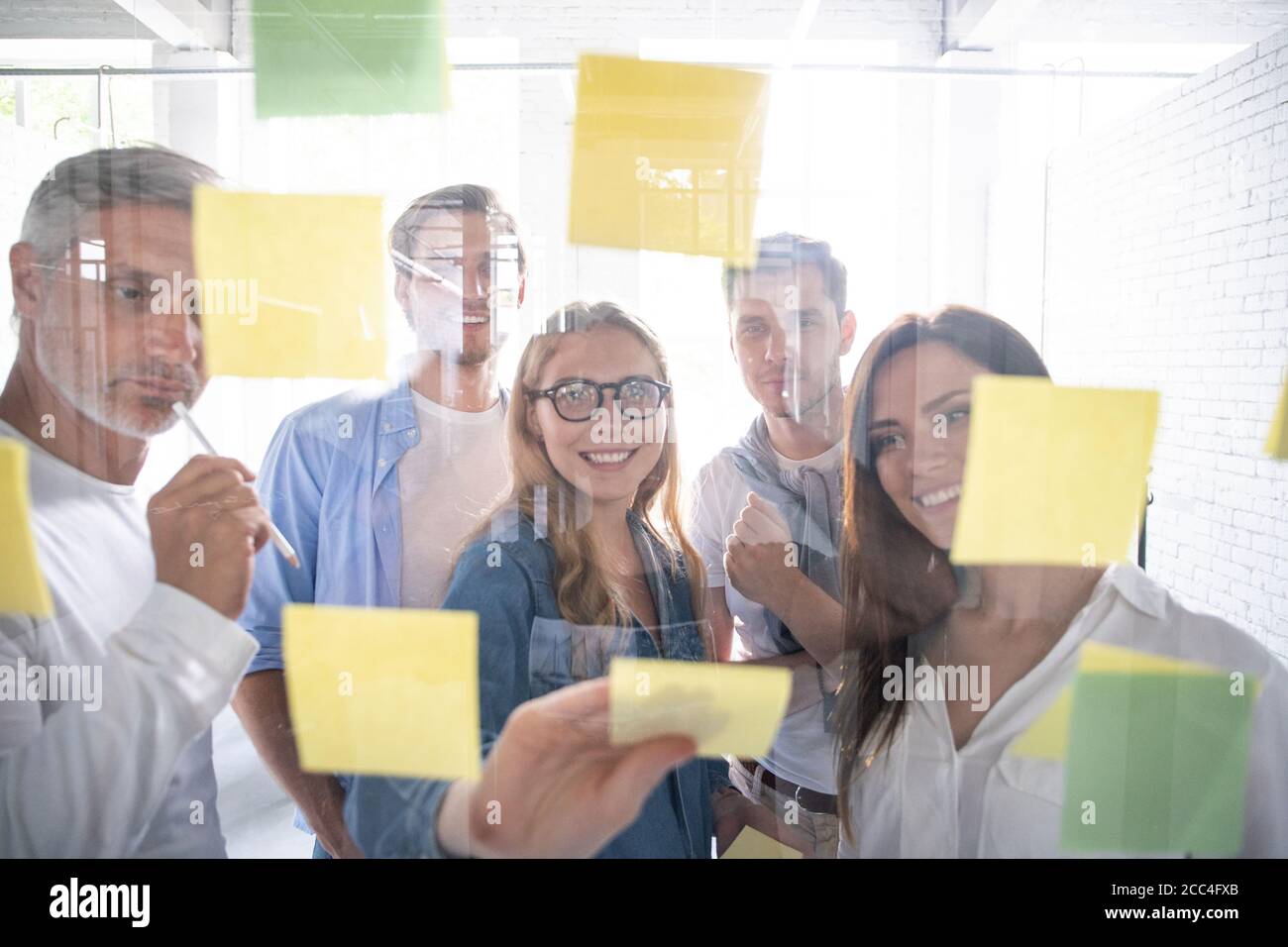 Business people meeting at office and use post it notes to share idea ...