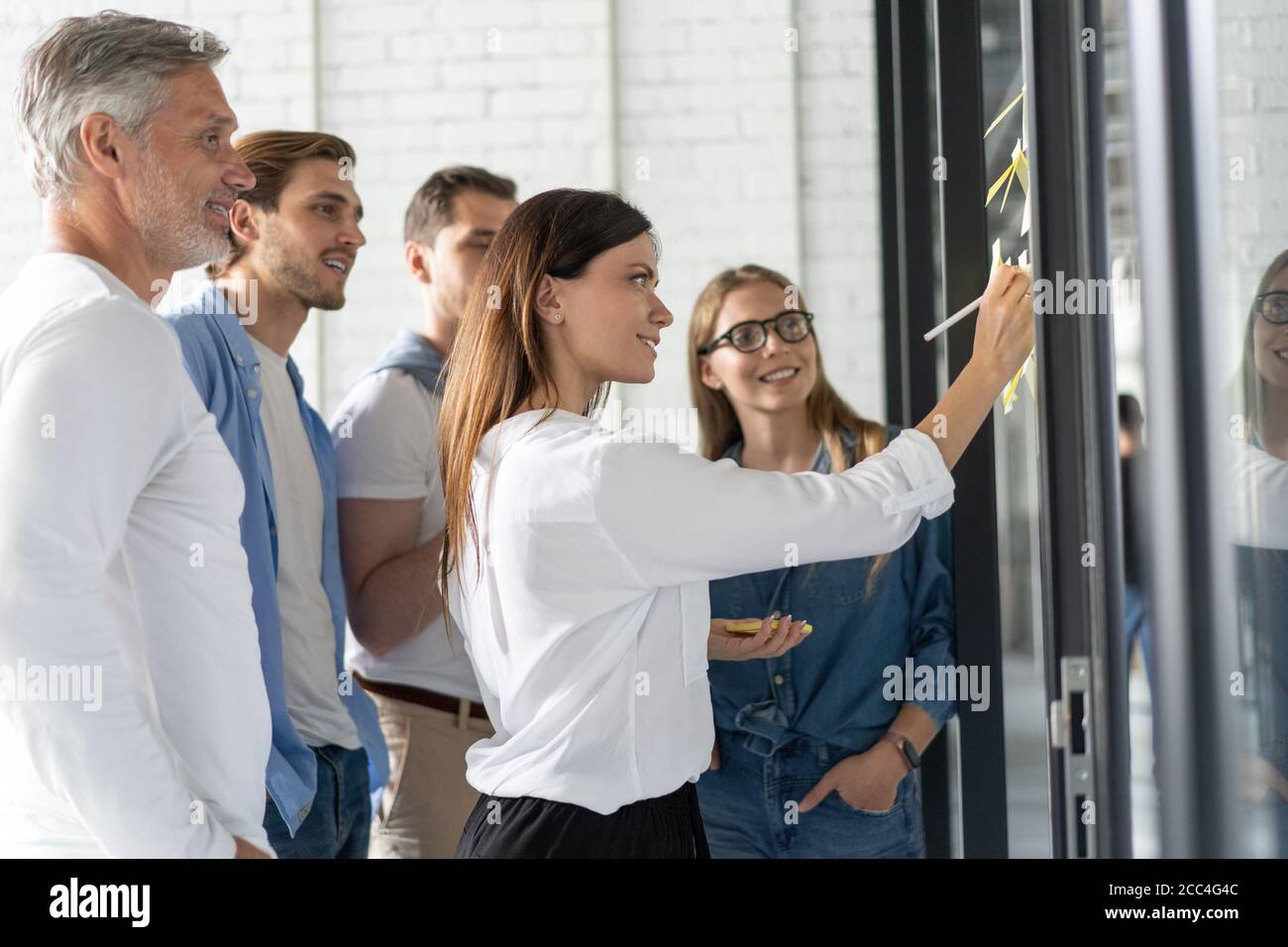 Business people meeting at office and use post it notes to share idea ...