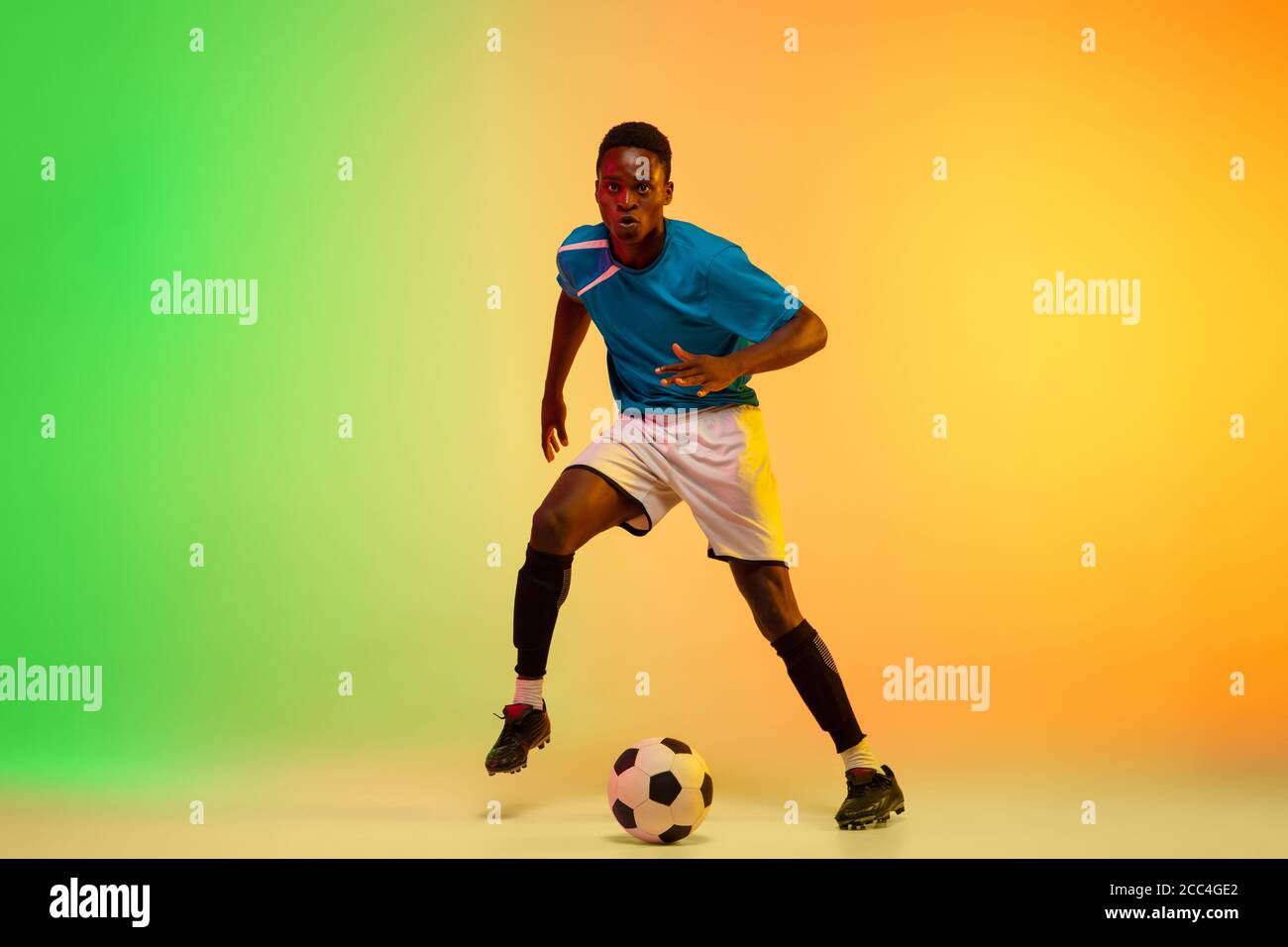 Leader. African-american male soccer, football player training in ...