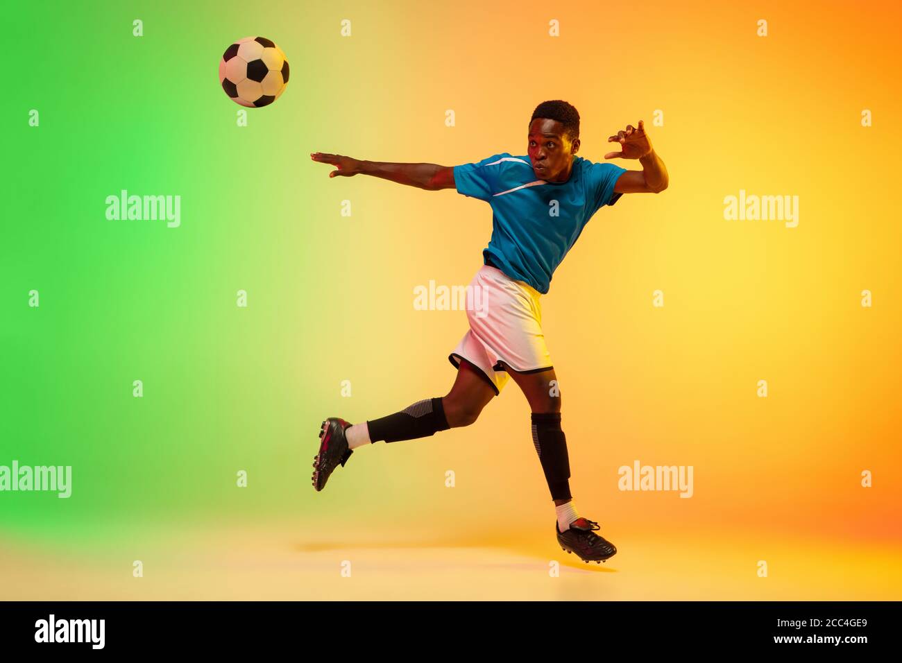 High jumping. Male soccer, football player training in action isolated ...