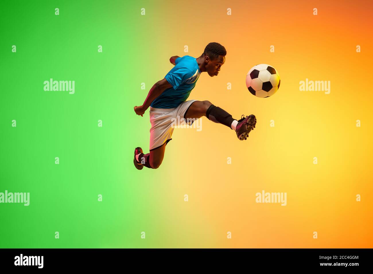 High jumping. Male soccer, football player training in action isolated ...