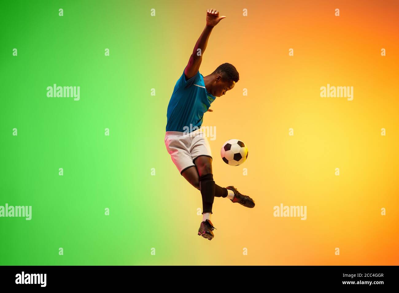 High jumping. Male soccer, football player training in action isolated ...