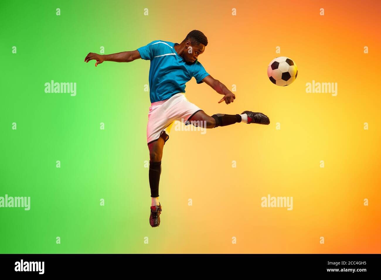 High jumping. Male soccer, football player training in action isolated ...