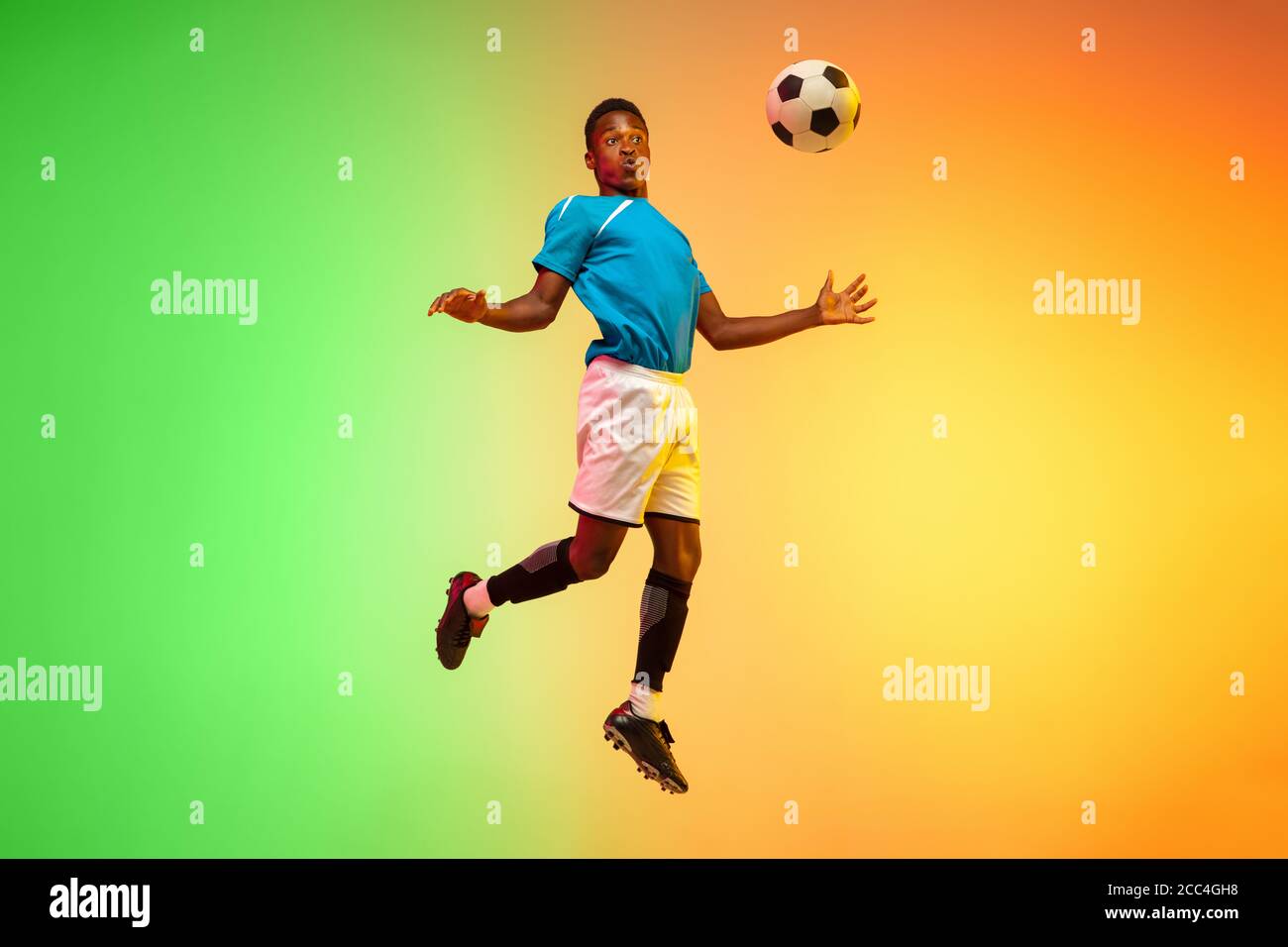 High jumping. Male soccer, football player training in action isolated ...
