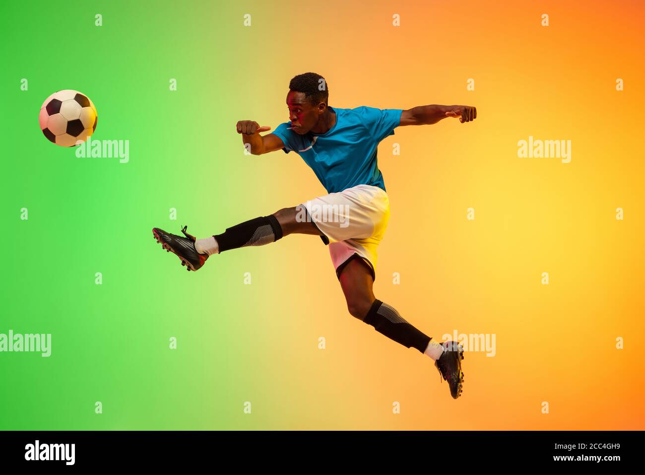 High jumping. Male soccer, football player training in action isolated ...