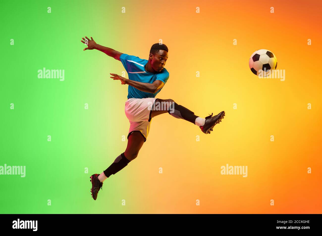 High jumping. Male soccer, football player training in action isolated ...