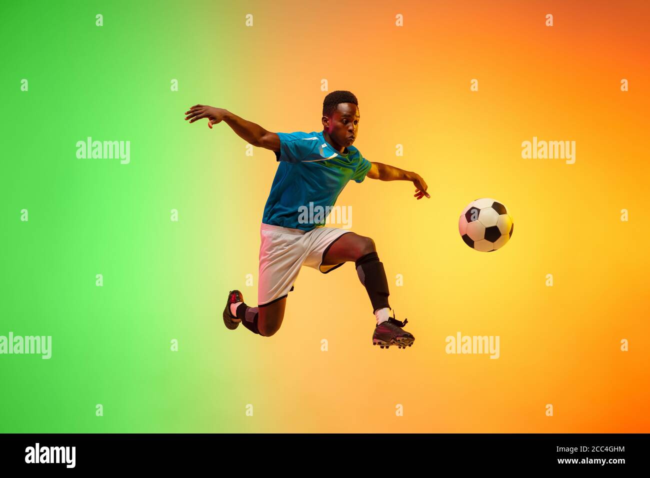 High jumping. Male soccer, football player training in action isolated ...