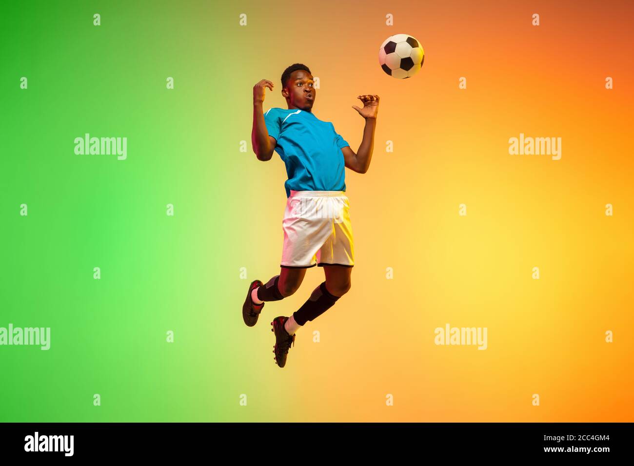 High jumping. Male soccer, football player training in action isolated ...