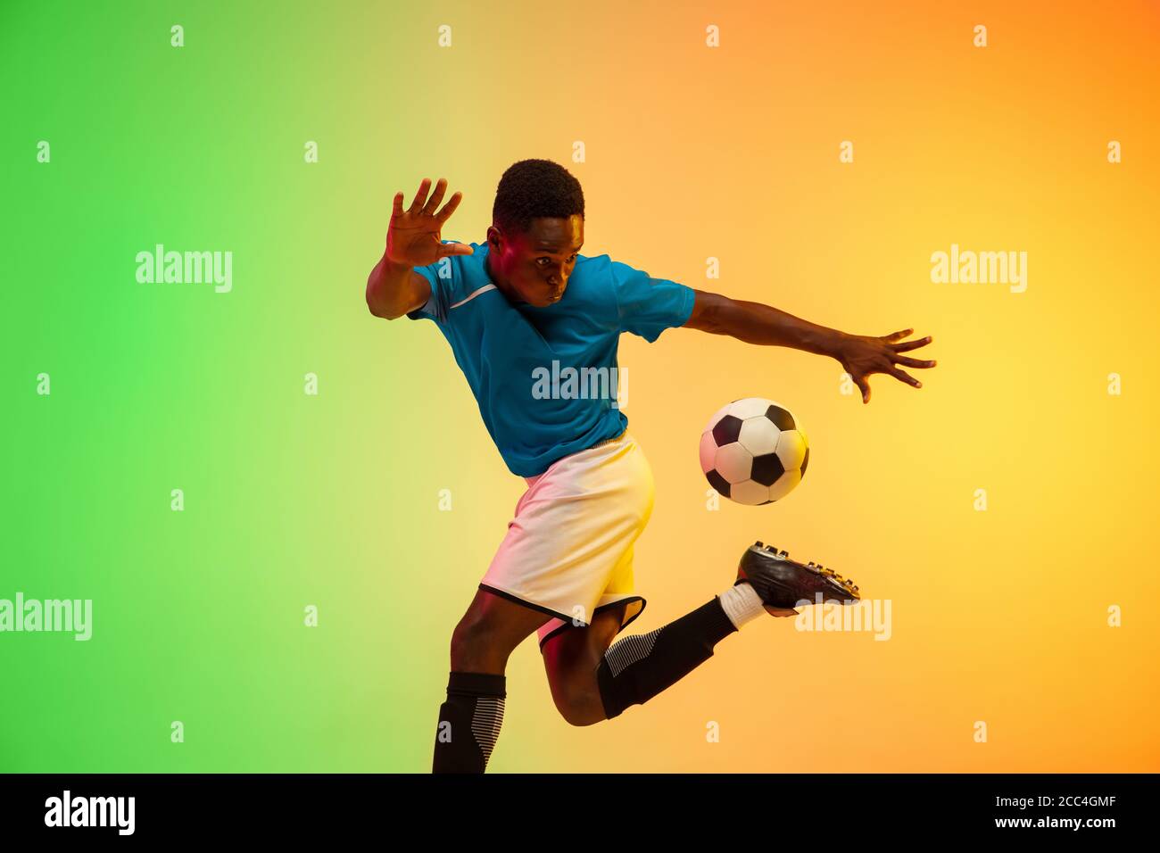 High jumping. Male soccer, football player training in action isolated ...