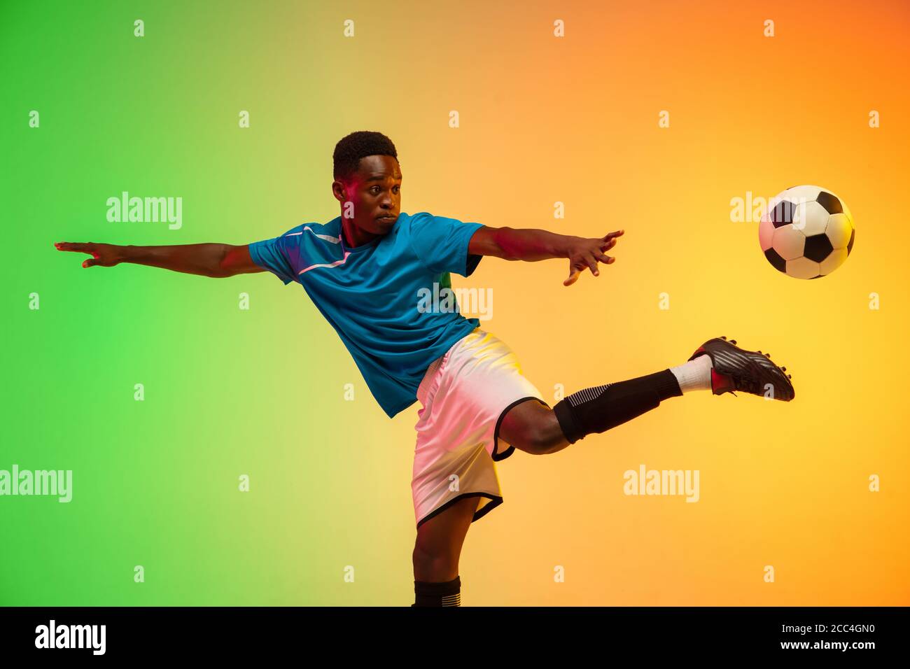 High jumping. Male soccer, football player training in action isolated ...