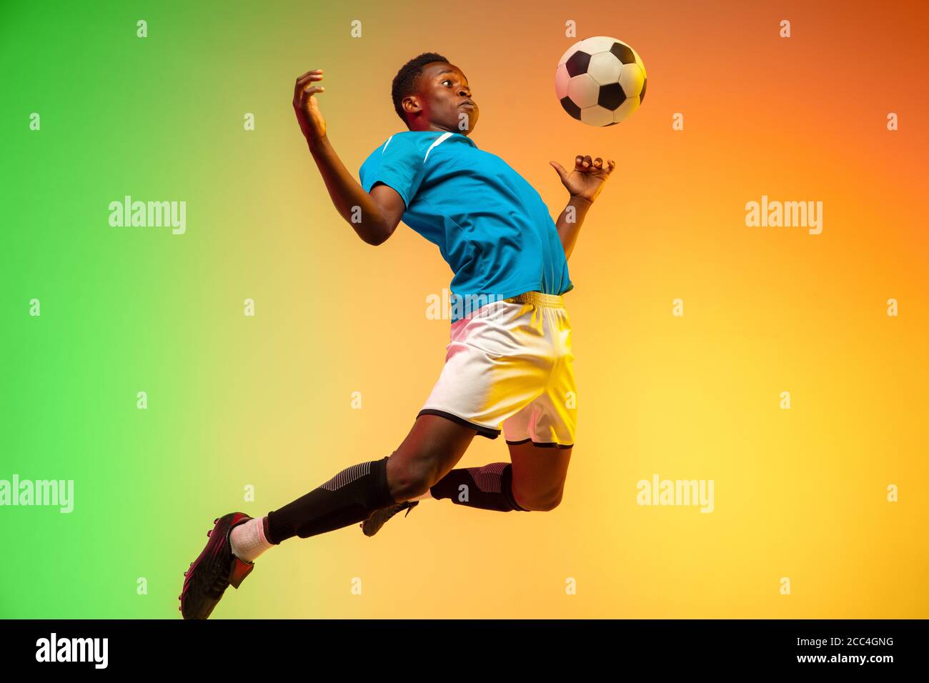 High jumping. Male soccer, football player training in action isolated ...