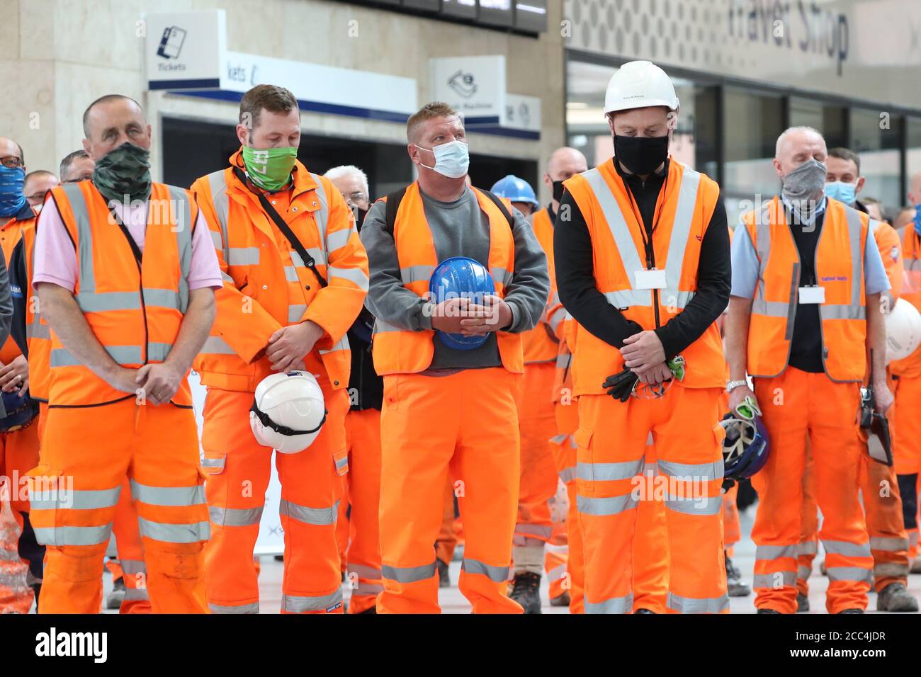 Rail staff stand in Glasgow Queen Street station during a minute's ...