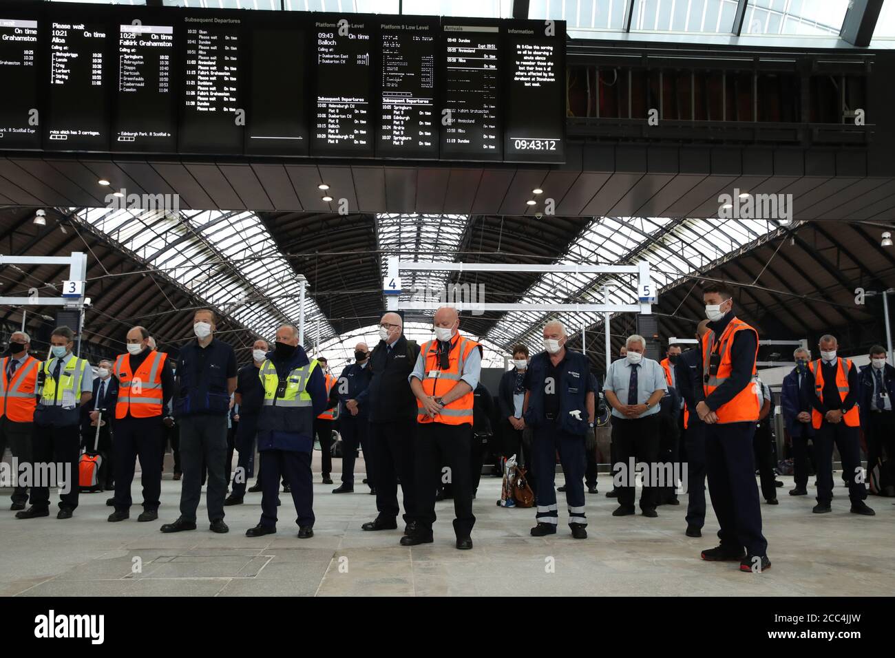 Members of the public join rail staff as they stand in Glasgow Queen ...