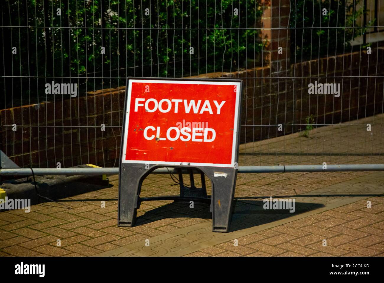 A footway closed sign blocking a path at night Stock Photo - Alamy