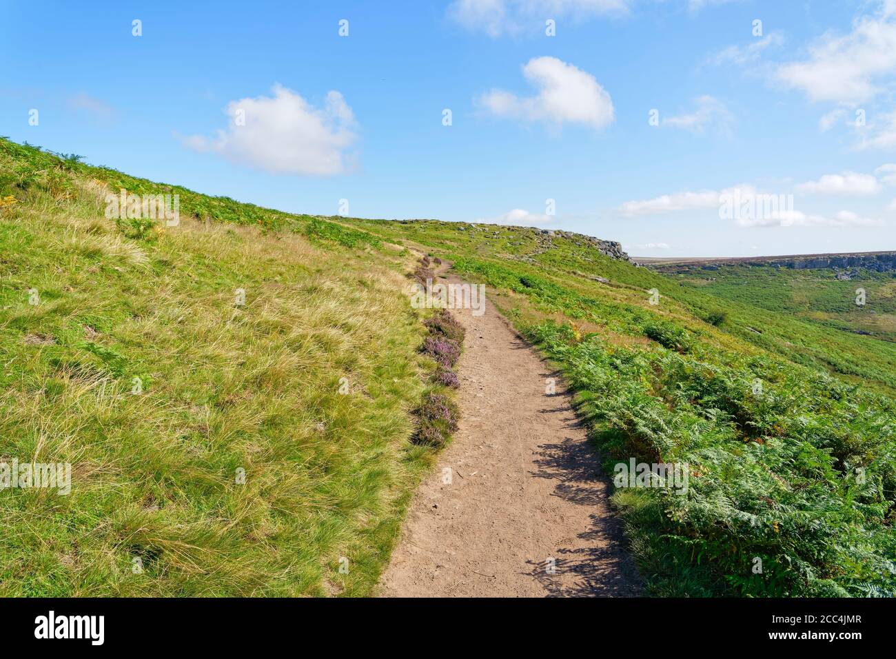 Narrow winding path across Burbage Moor in the Derbyshire Peak District ...