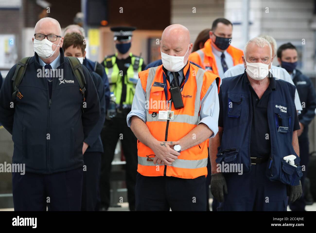 Rail staff stand in Glasgow Queen Street station during a minute's ...