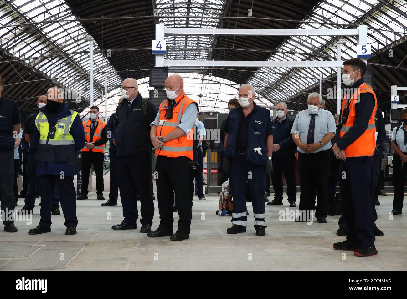 Rail staff stand in Glasgow Queen Street station during a minute's ...