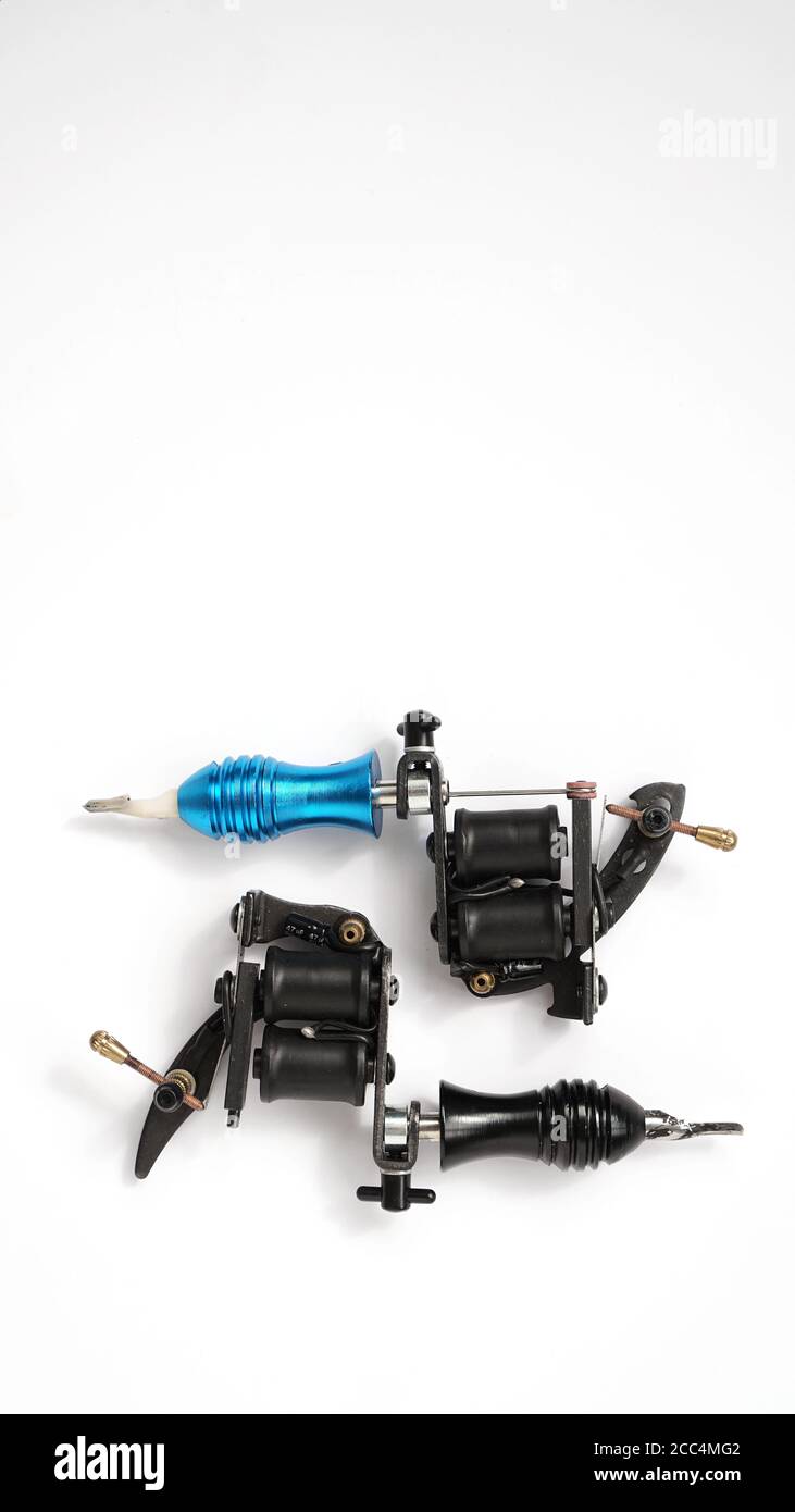 Two tattoo machines on a white background - vertical photo- tattoo ...