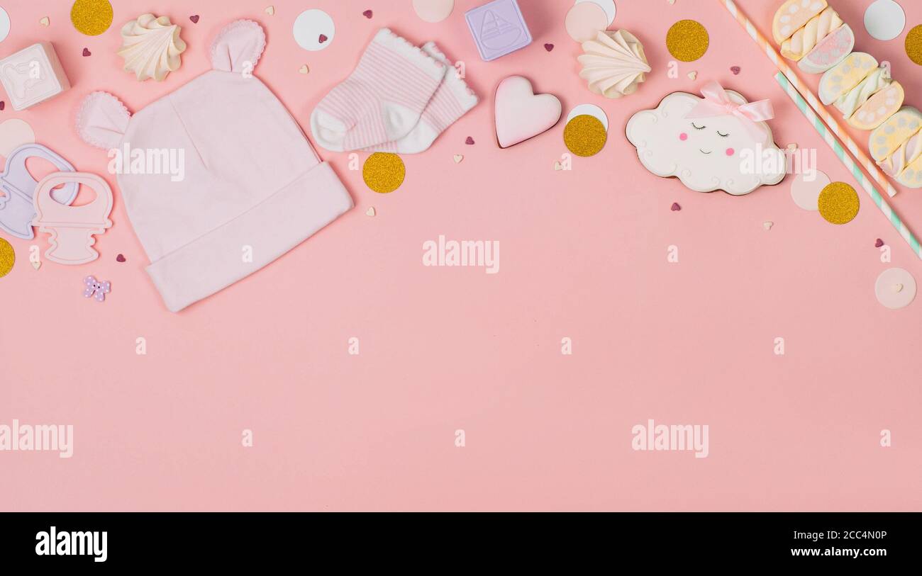 Baby shower party background with baby accessories and sweets on pink ...