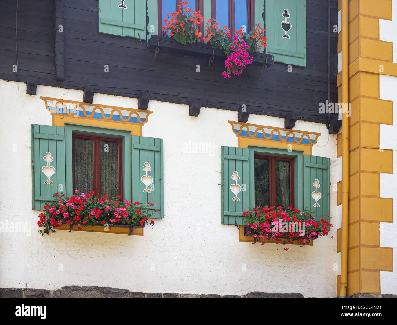 Facade of traditional austrian house with ancient wooden windows and ...