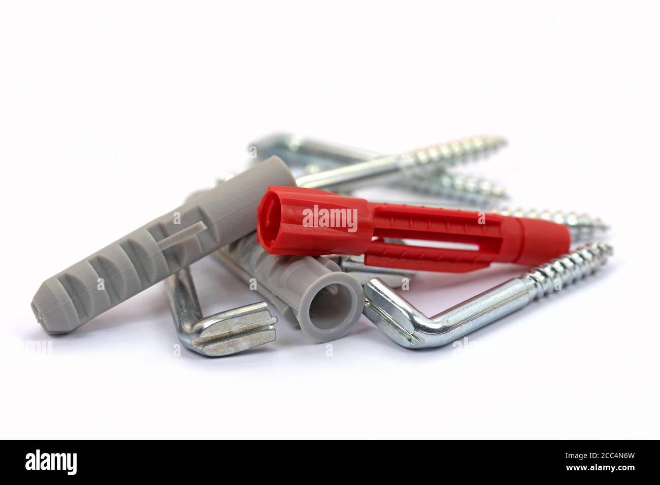 Dowels and angle screw hooks against a white background Stock Photo - Alamy