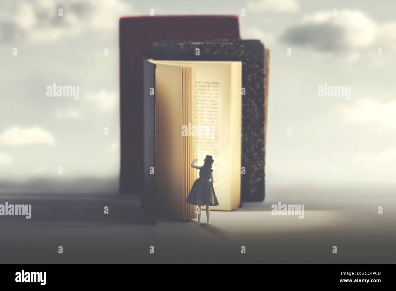 curious woman looks into a mysterious illuminated book Stock Photo - Alamy