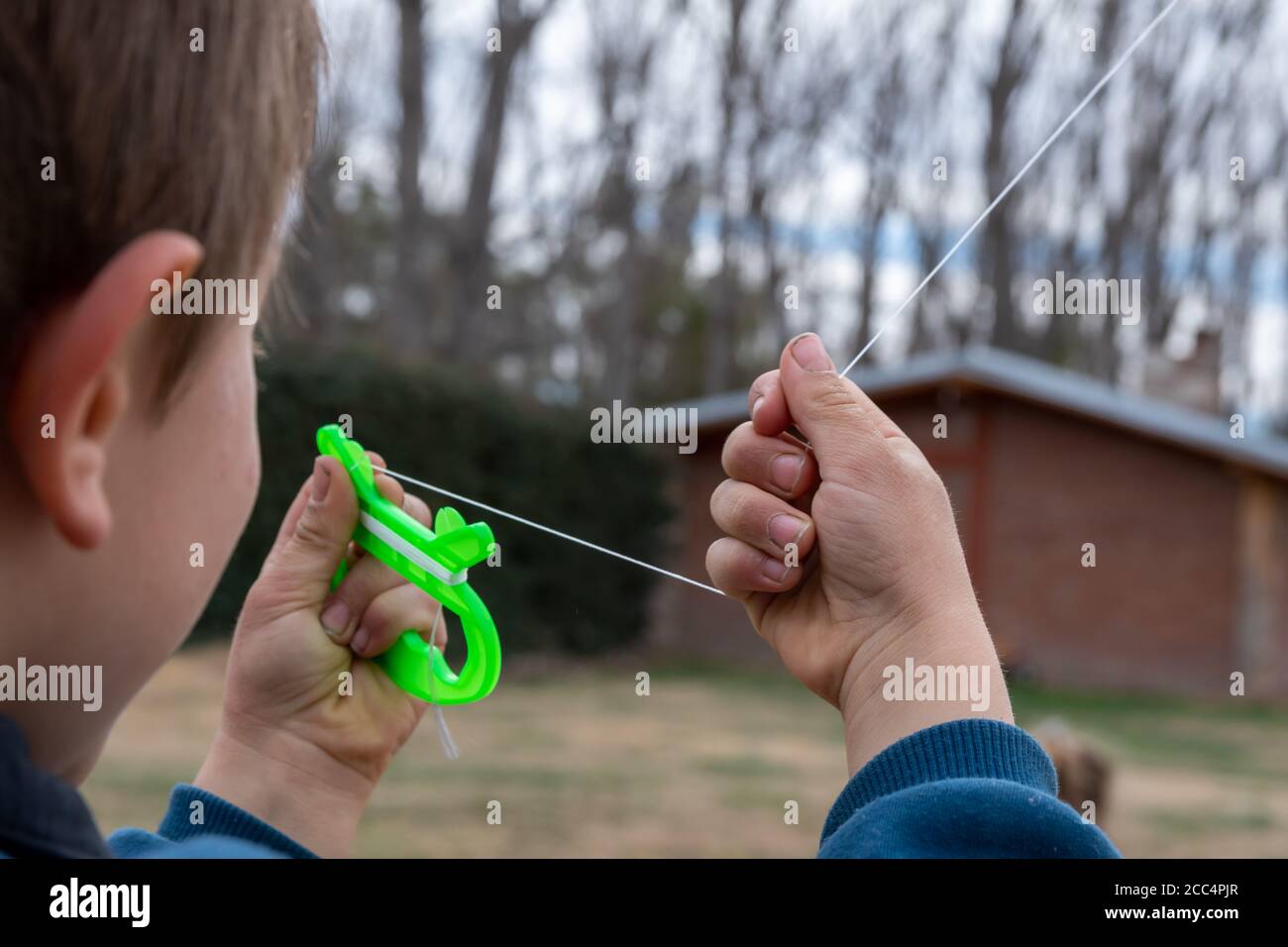 Little boy holding the threads of a kite Stock Photo - Alamy