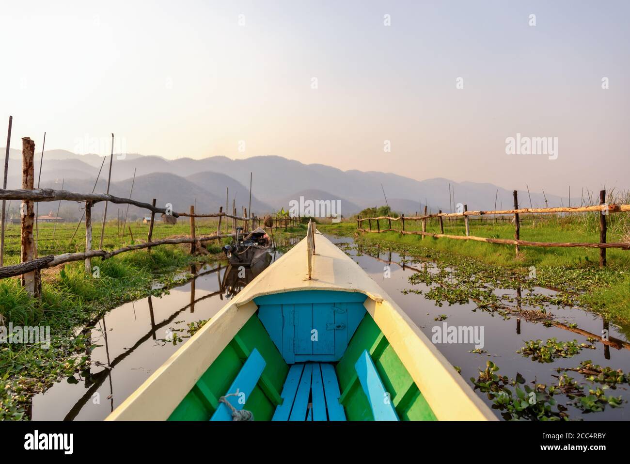 Boat tour in the floating gardens of Inle lake at sunset in Burma ...