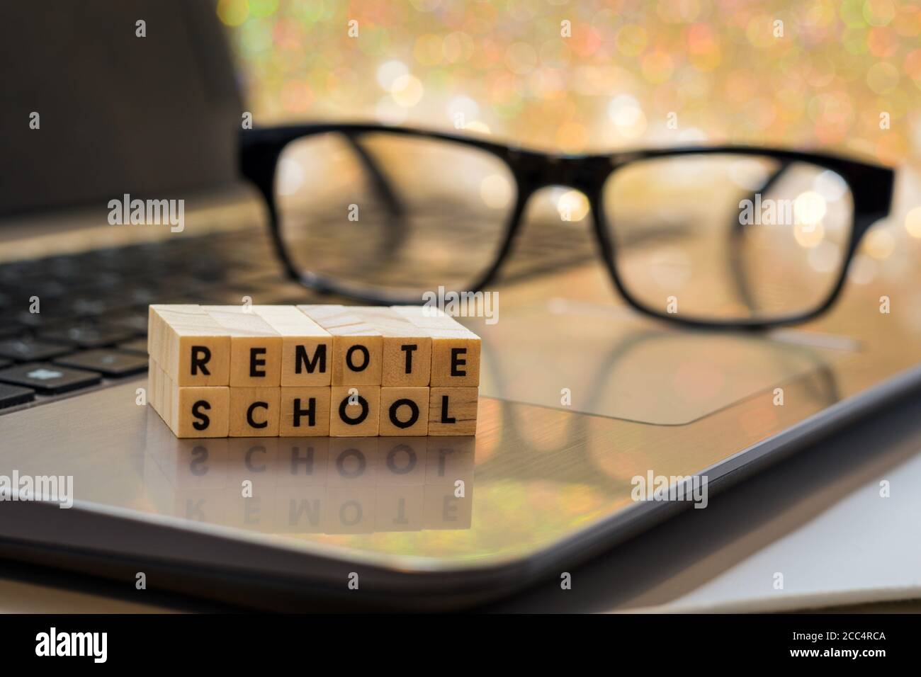 REMOTE SCHOOL virtual learning concept with wood block letters on ...