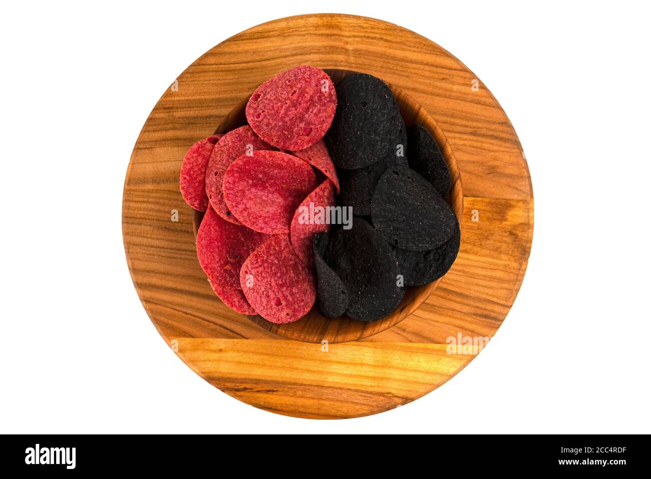 Black and red spicy chips in a wooden plate. Isolate. Studio shot Stock ...