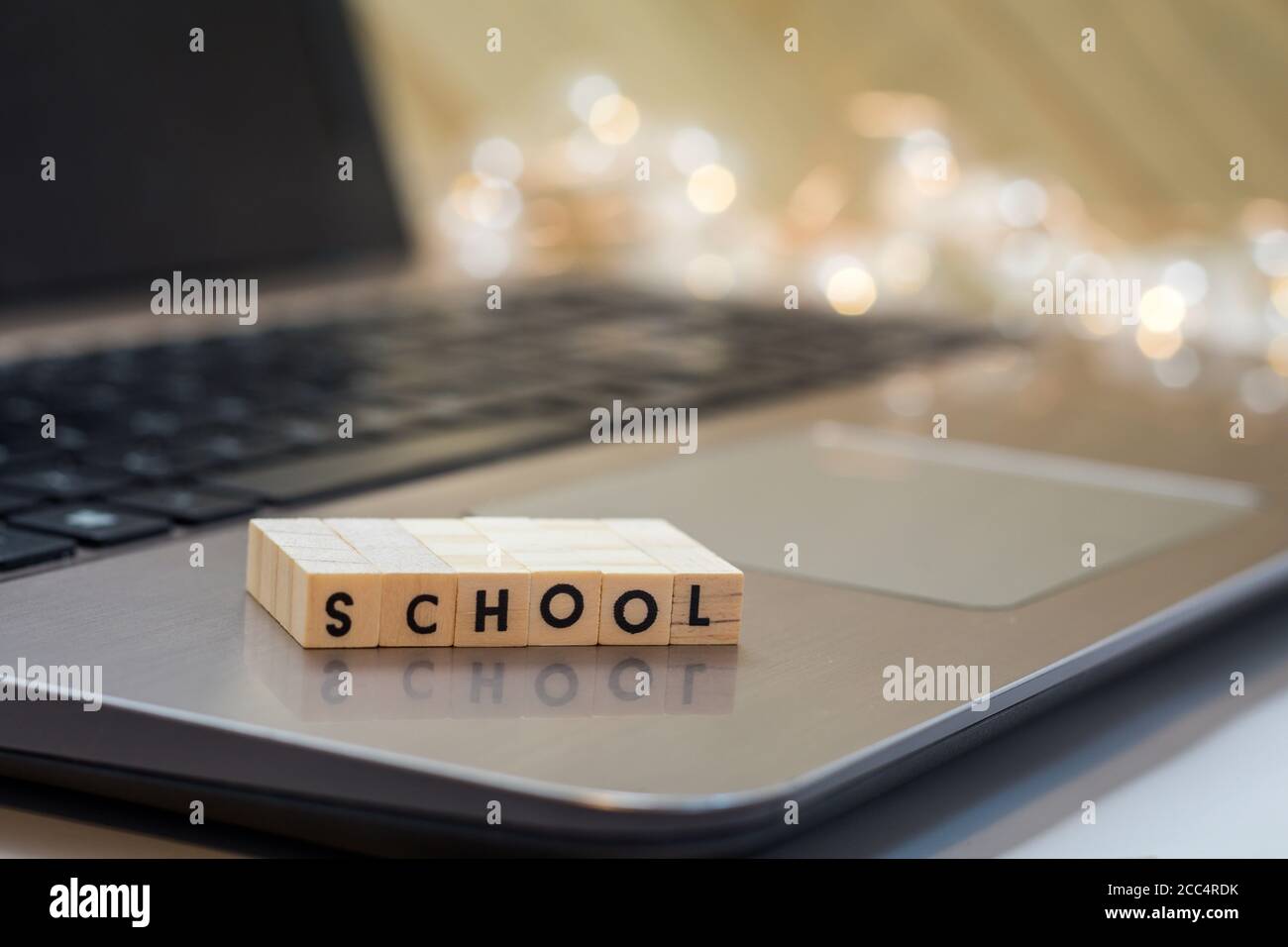 SCHOOL virtual learning concept with wood block letters on laptop ...