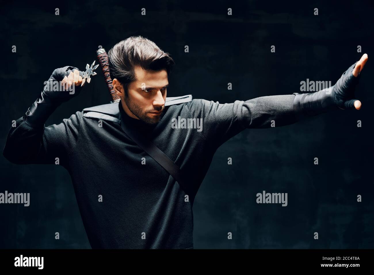 Warrior fighter with a sword and shuriken ready to stab enemy over ...