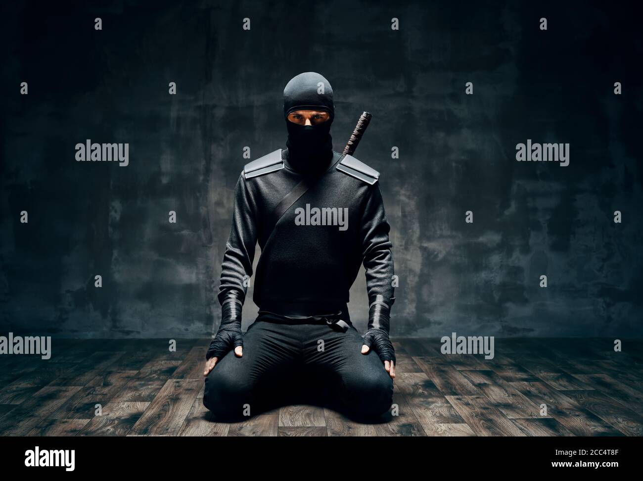 Ninja kneeling posing with a sword over black background. japanese ...