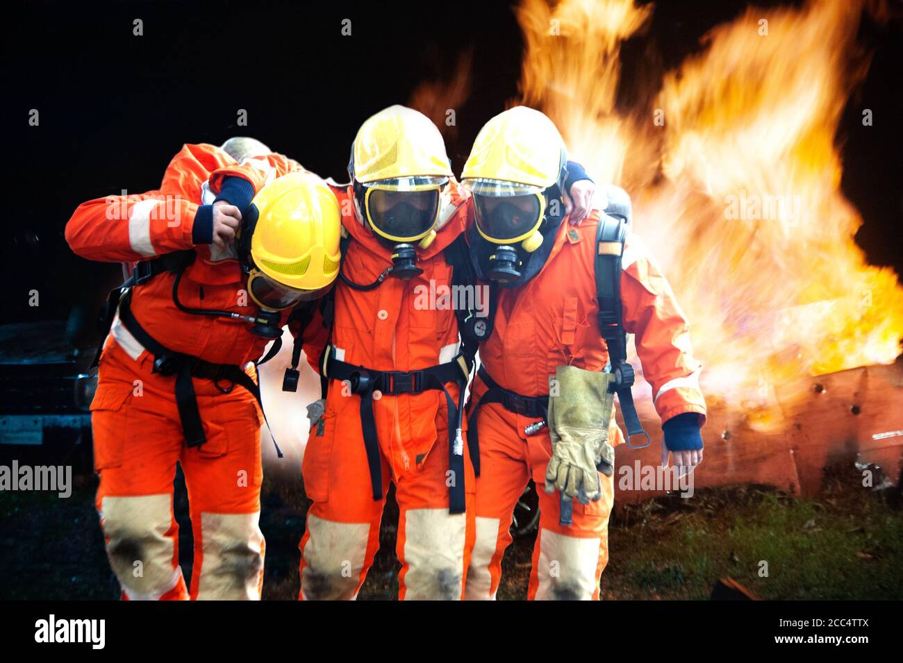 Firefighters are helping workers by pulling out of the burning building ...