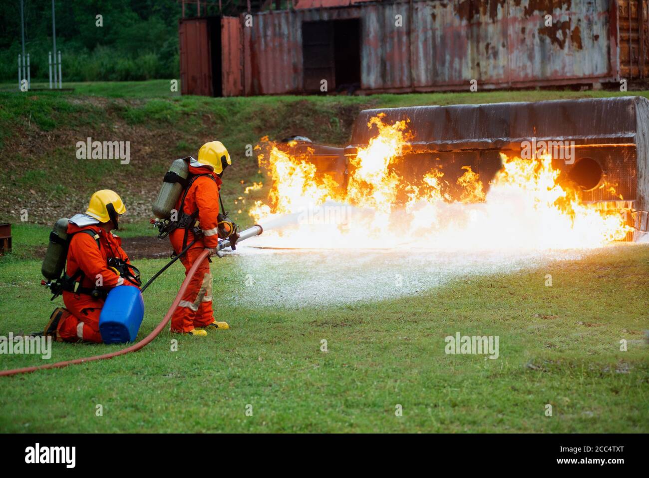 Firefighters fire truck spraying water hi-res stock photography and ...