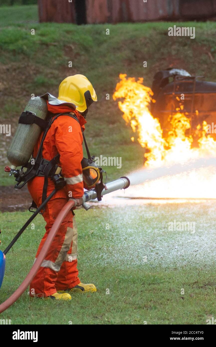 Firefighters fire truck spraying water hi-res stock photography and ...
