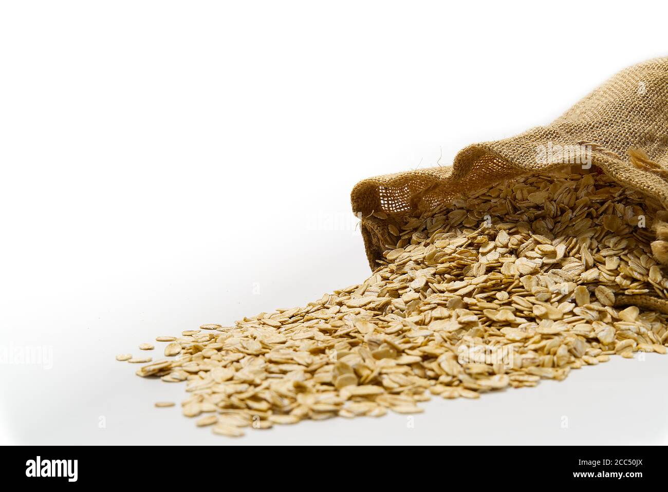 Brown Linen bag of rolled organic healthy oats on a white background ...