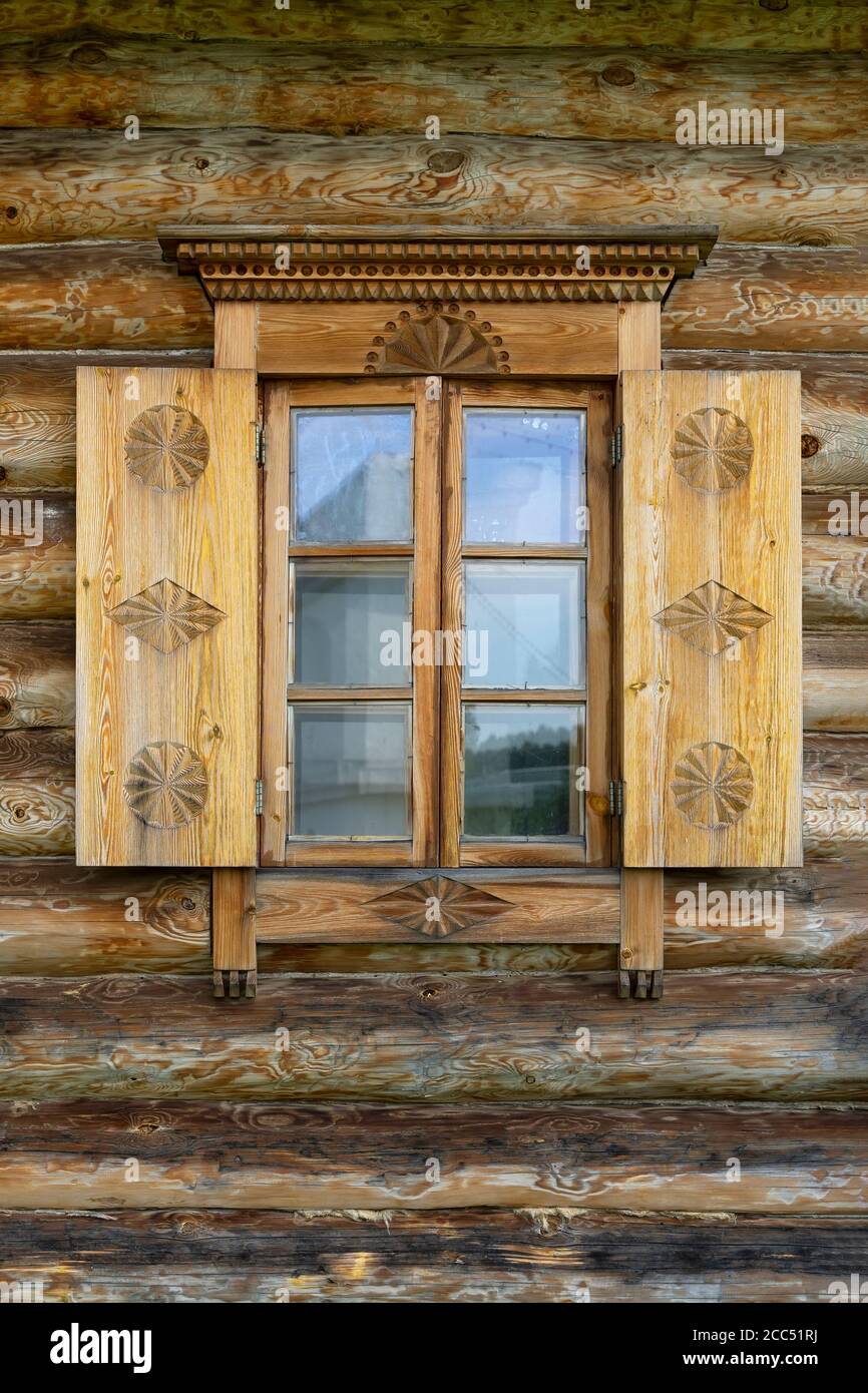 Natural wooden window with shutters, decorated with carved patterns ...