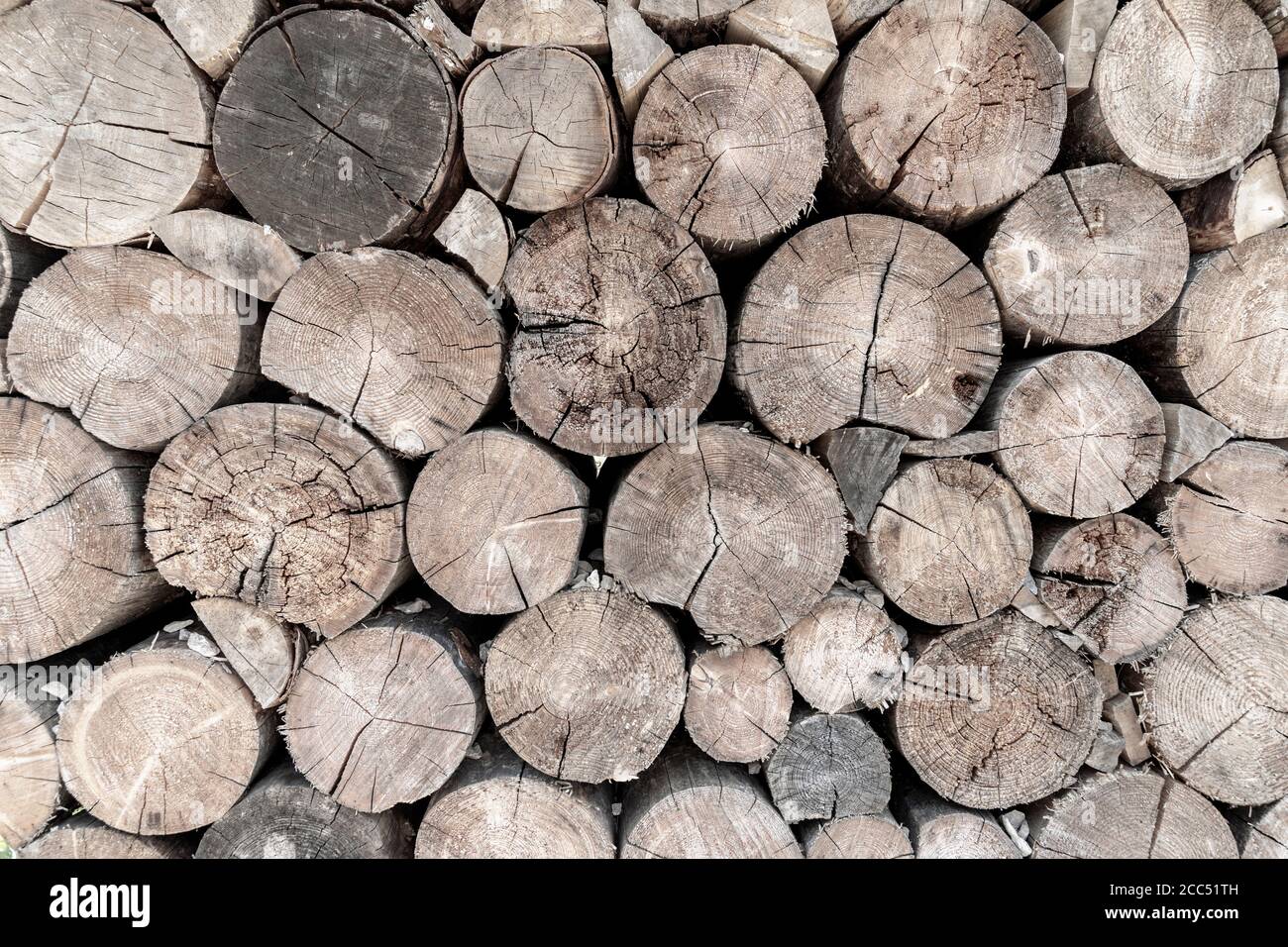 Folded stack, pile of wooden sawn logs with cross section of the timber ...